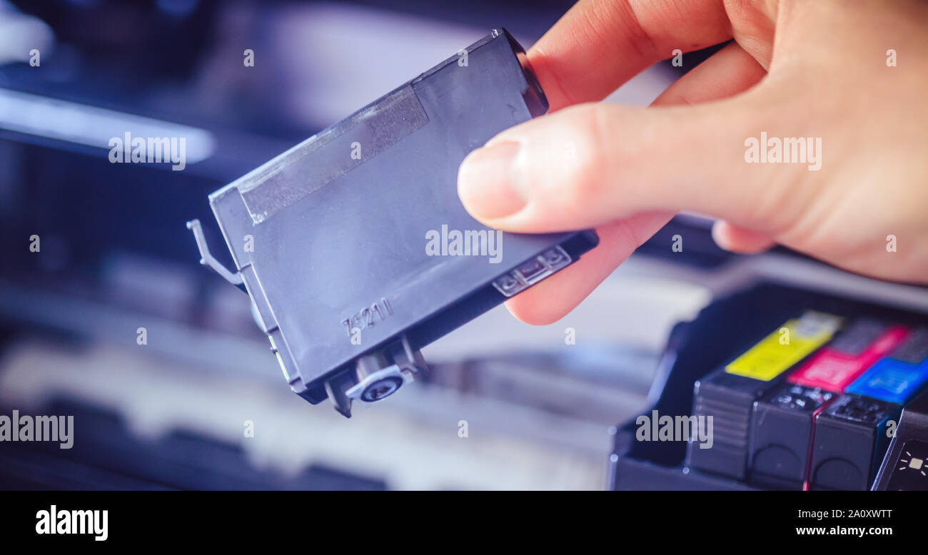 Putting new printer cartridge into the printer, inkjet Stock Photo - Alamy