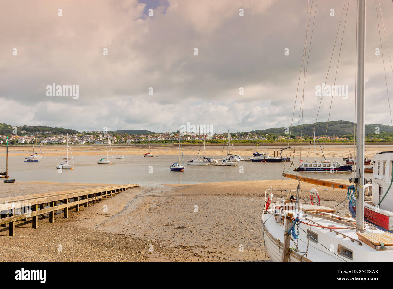 St George’s Channel at Conwy. Two boats are moored close to a slipway ...