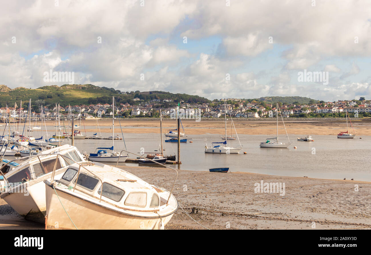 St George’s Channel at Conwy. Two boats are aground on the sand and ...