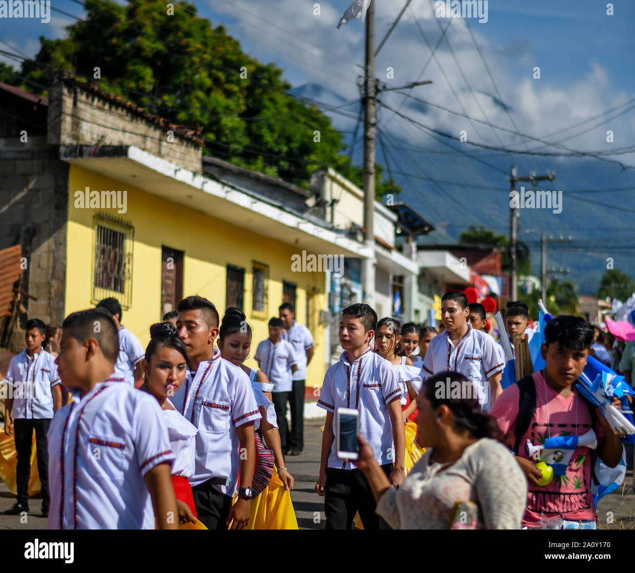 Hispanic teens walking/marching in Guatemalan independence day parade ...