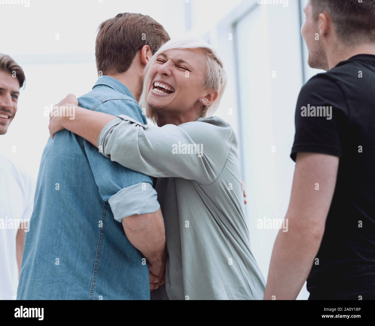 happy coworkers hugging each other when meeting Stock Photo - Alamy