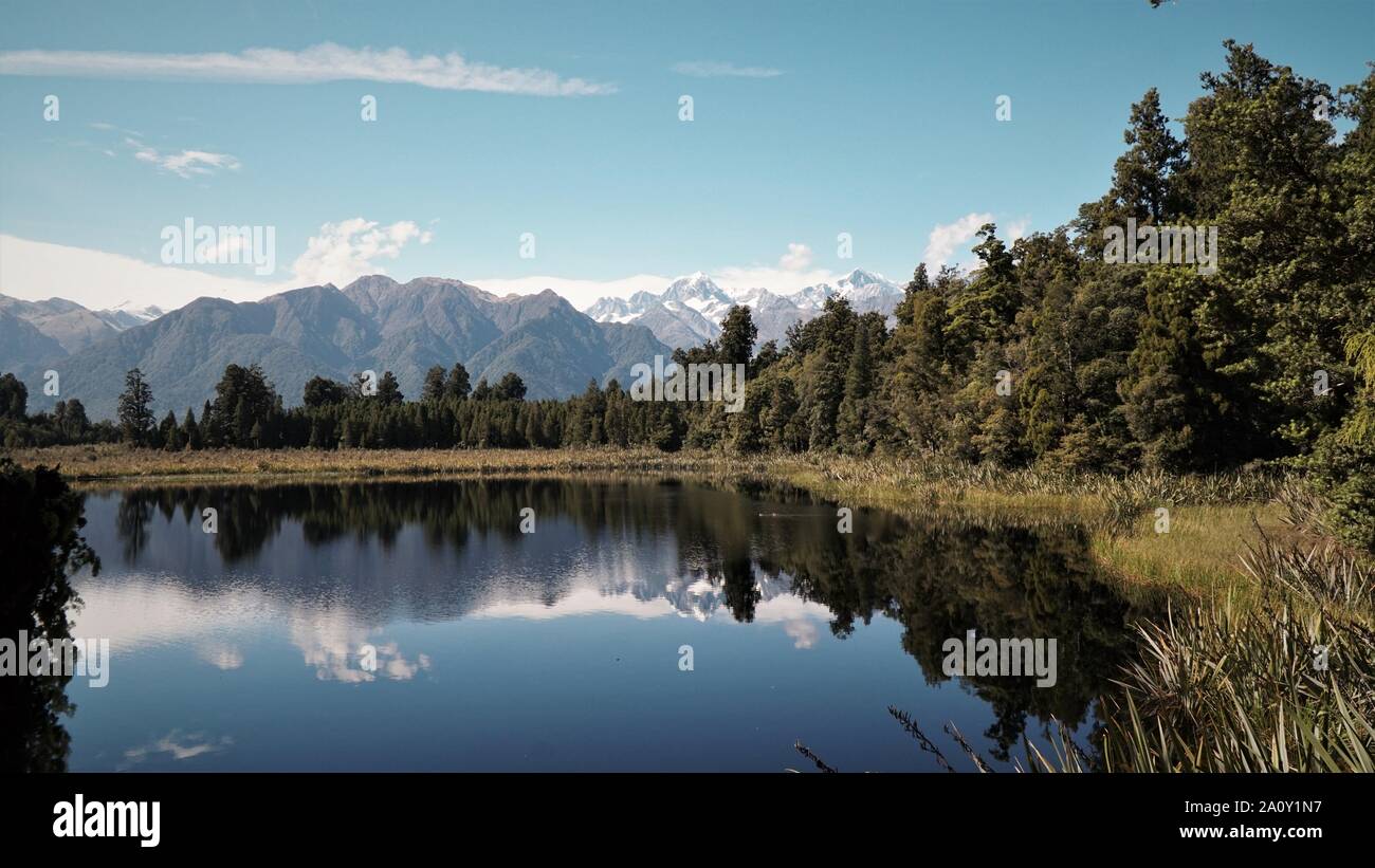 Lake Matheson perfect reflection of mountains in waters of clear lake ...