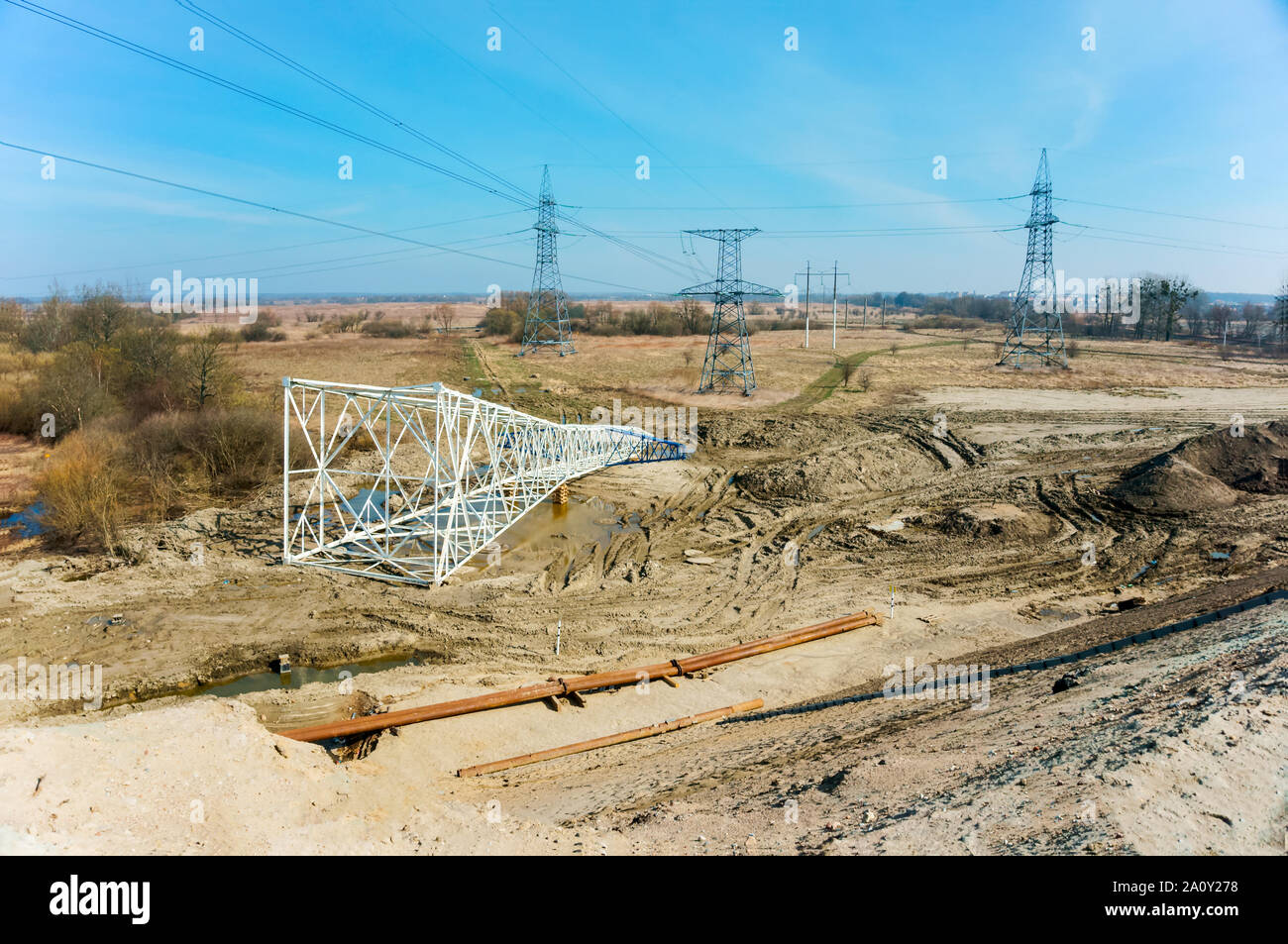 replacing power towers, power pole lying on the ground Stock Photo - Alamy