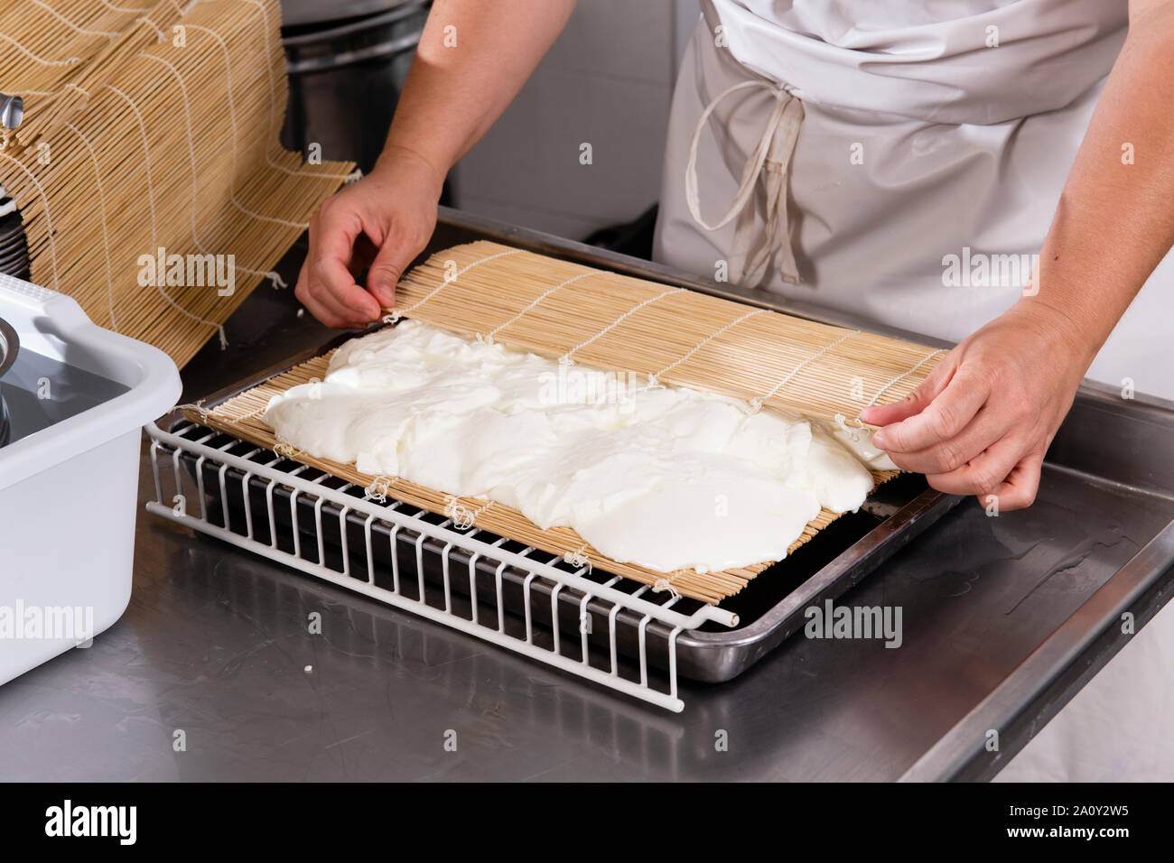 Cheesemaker puts fresh cheese on the rush for a typical process Stock ...