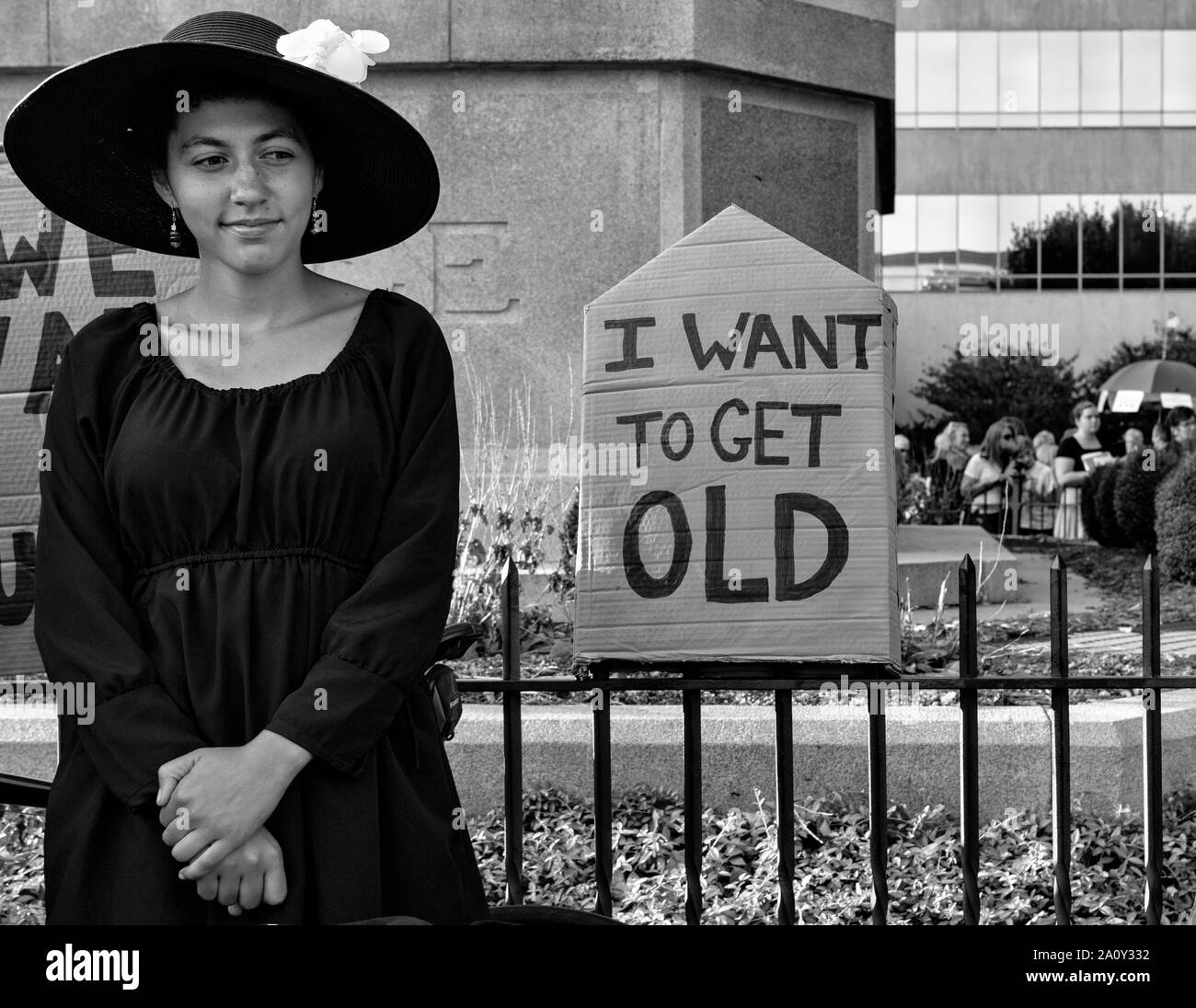 A young Gen Z protester stands next to her sign at the International ...