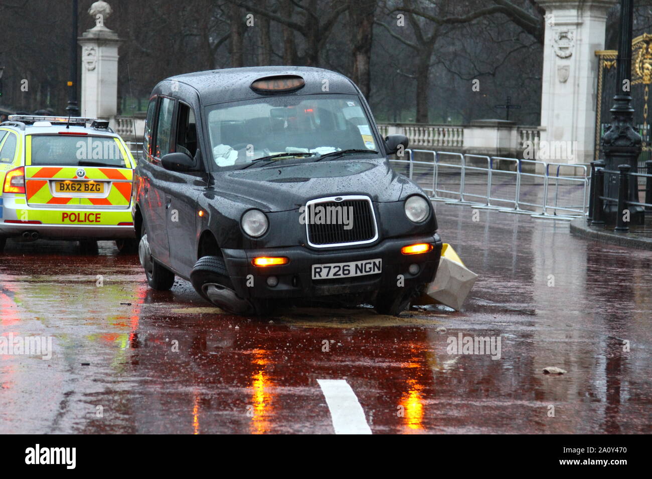 A London Black Taxi cab runs over a traffic Island in Constitution Hill ...