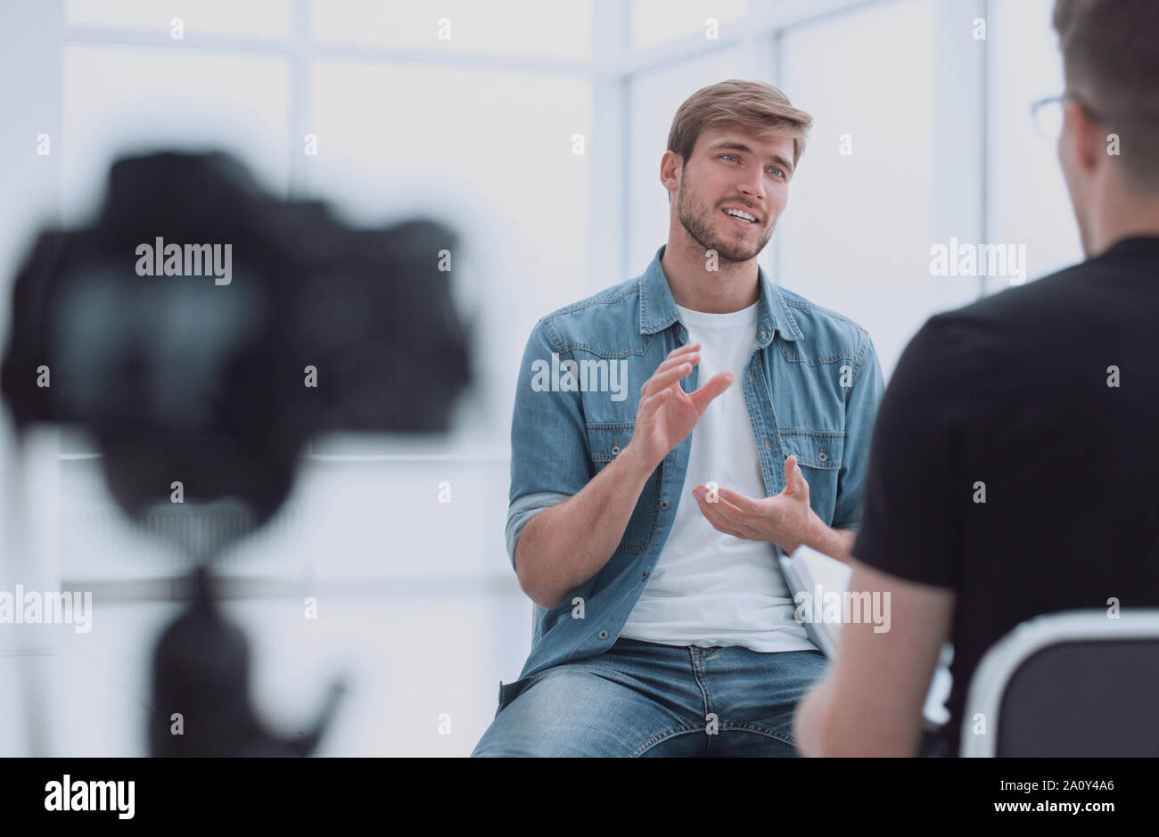 two young men talking in the TV Studio Stock Photo - Alamy