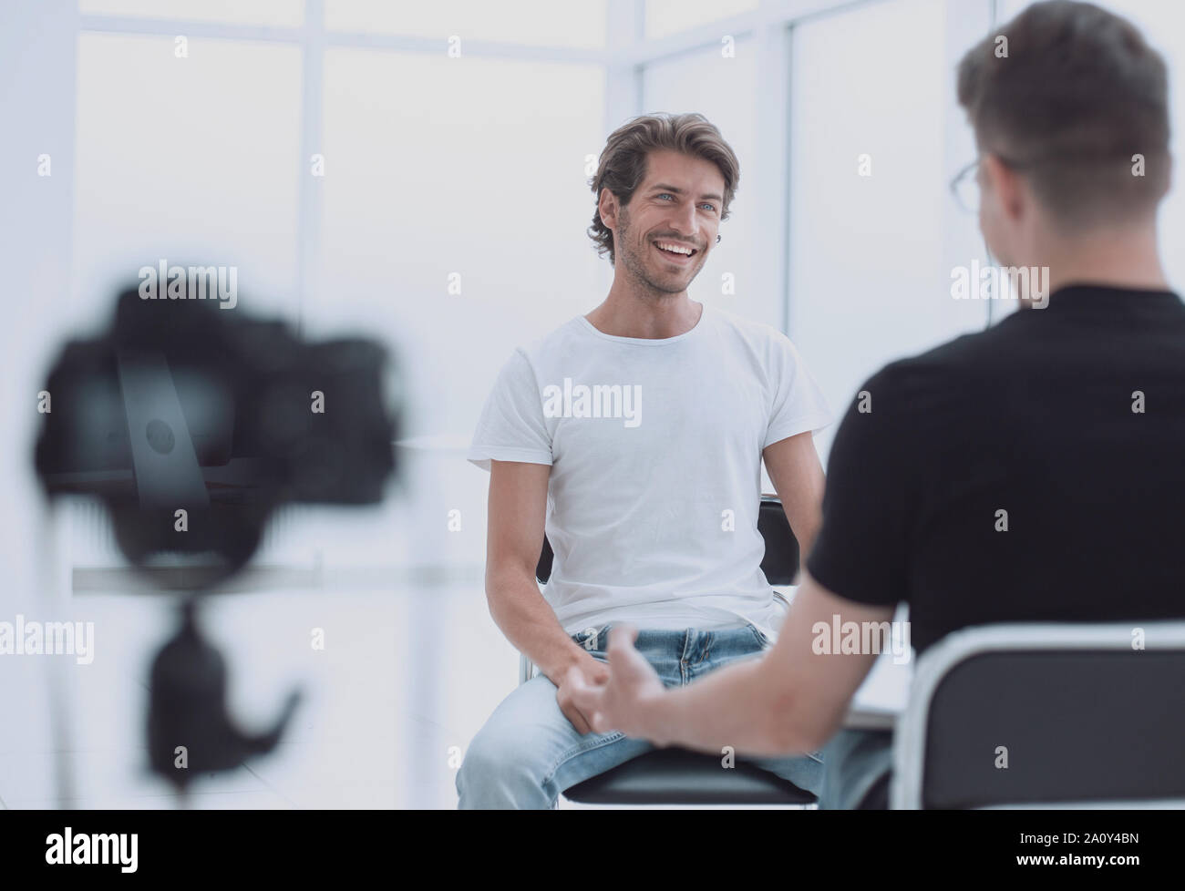 close up. a young businessman gives an interview in the office Stock ...
