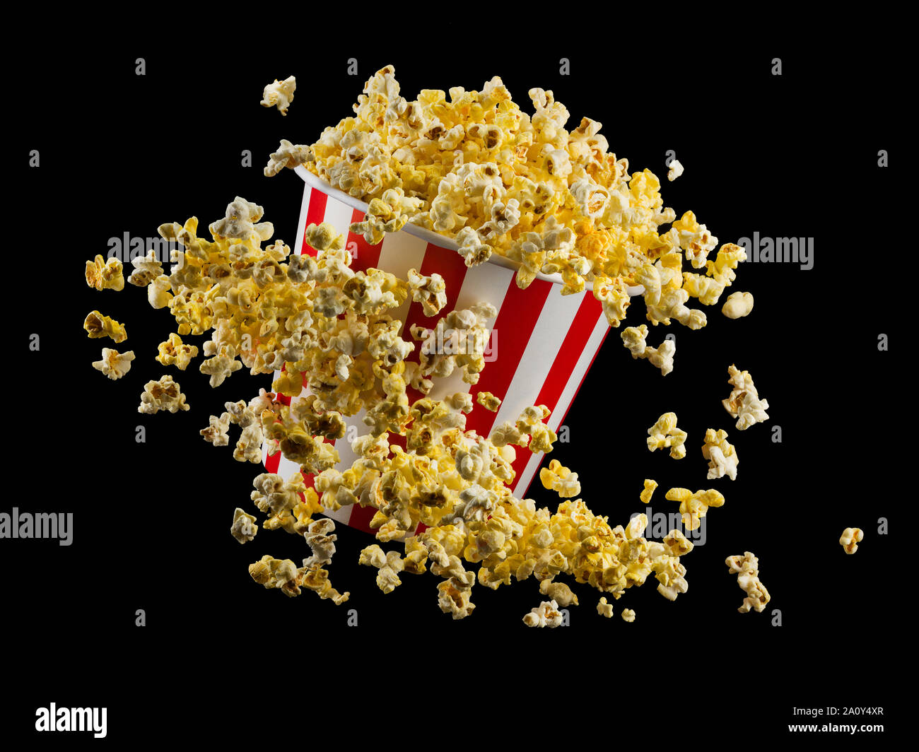 Flying popcorn from striped bucket isolated on black background Stock ...
