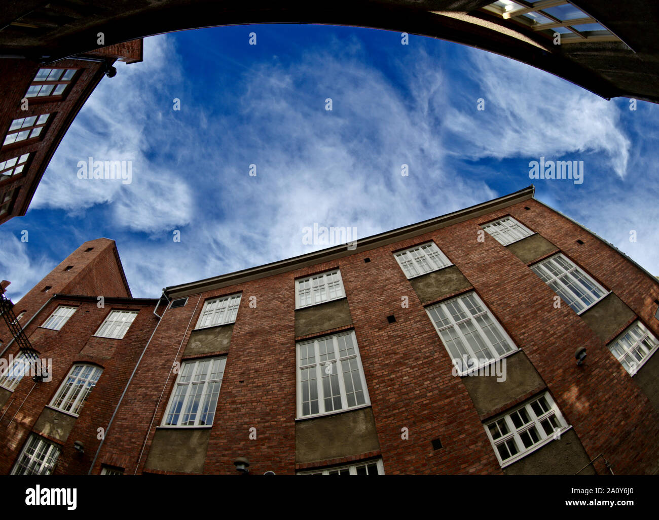 A fish eye image of an old factory building with blue sky above Stock ...