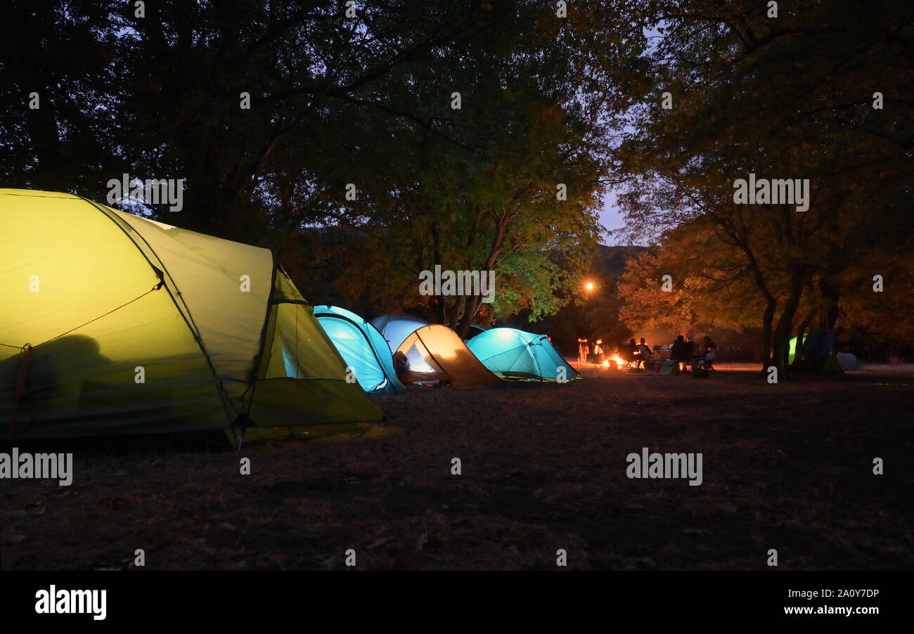 Tents and people outside in nature at night Stock Photo - Alamy