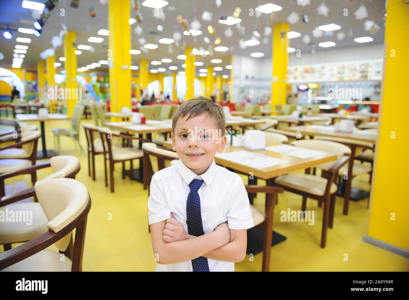 beautiful happy little boy smiling in white shirt and tie in yellow ...