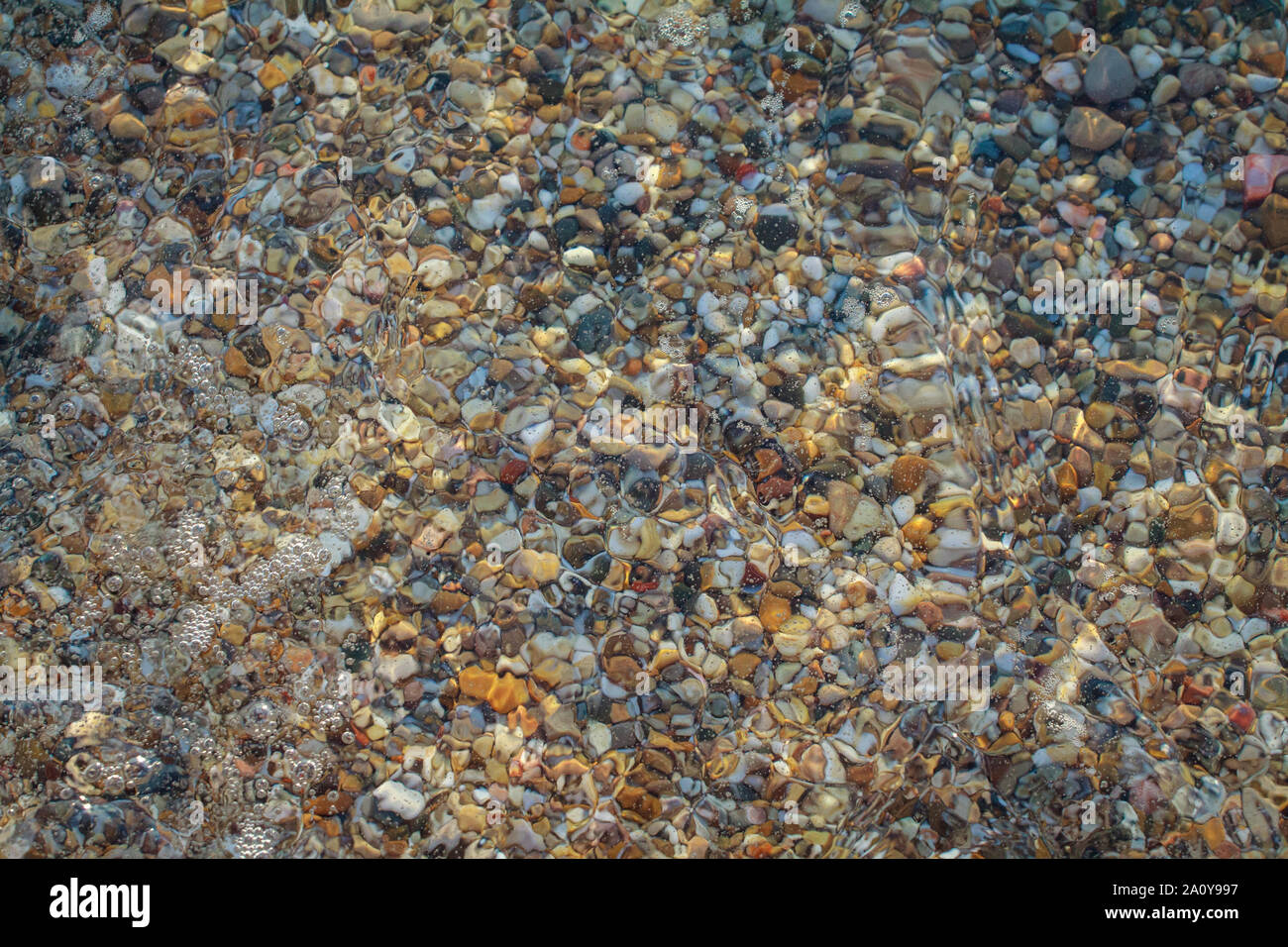 sea pebbles colored granite on the beach background stones. The shore ...