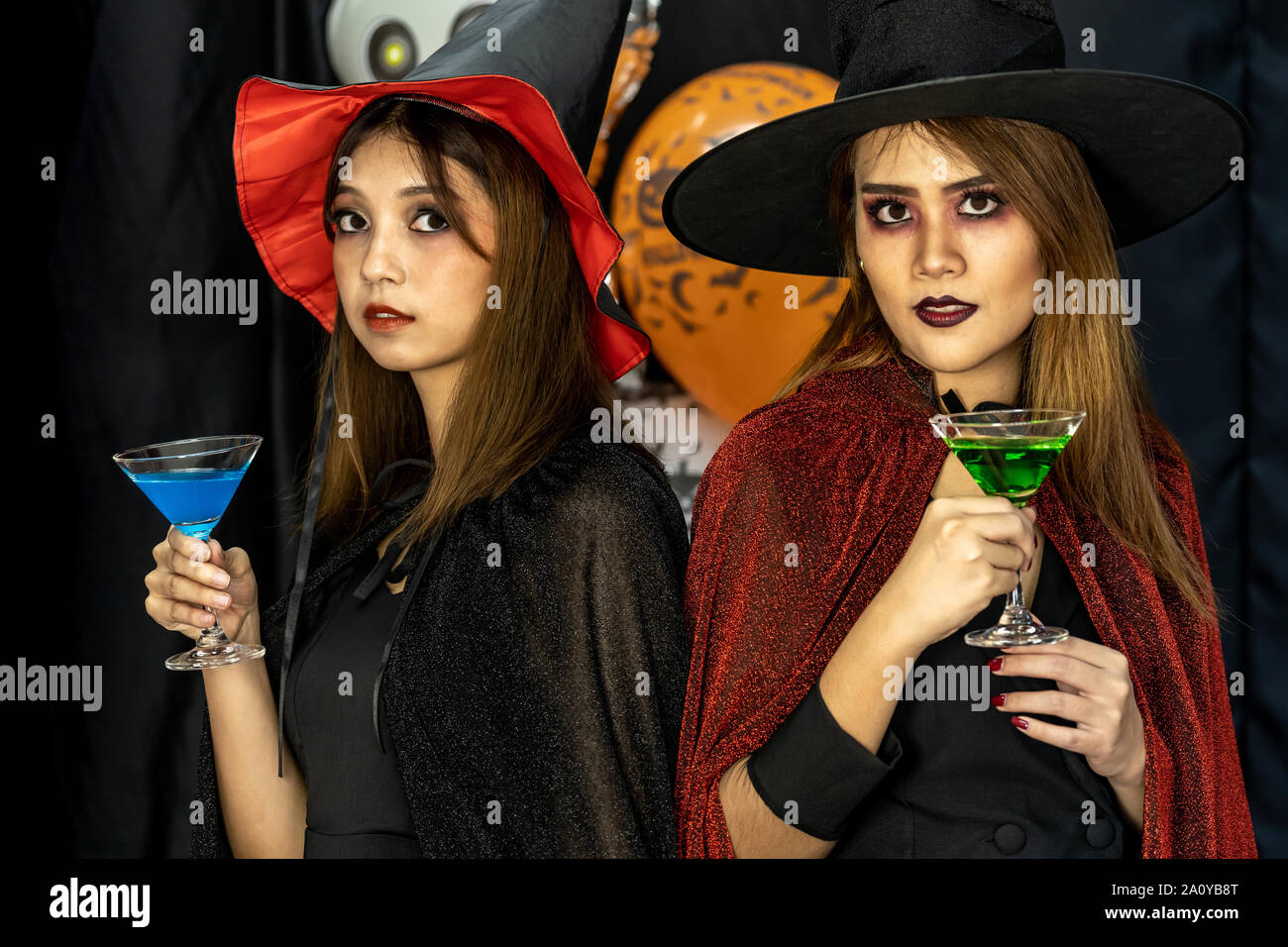 Two young adult and teenager girls celebrating a Halloween party ...