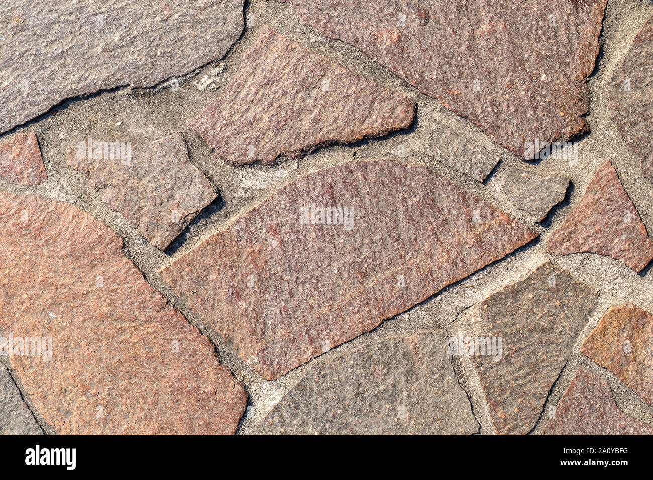 A wall of rough stones of irregular shape as a natural background for ...