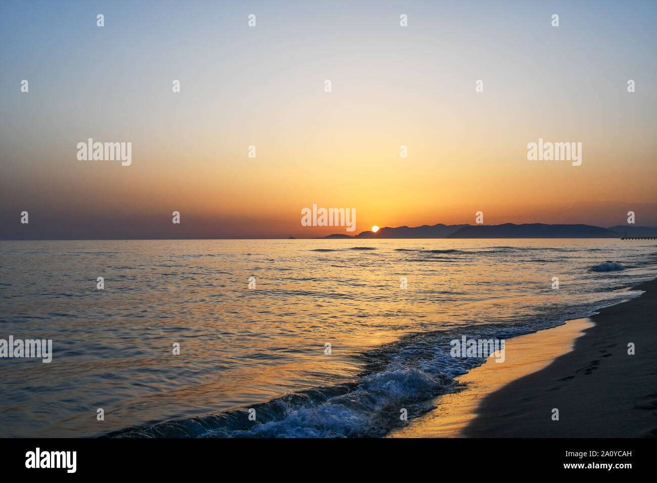 Sea sunset from the empty sandy beach of Forte dei Marmi with the sun ...