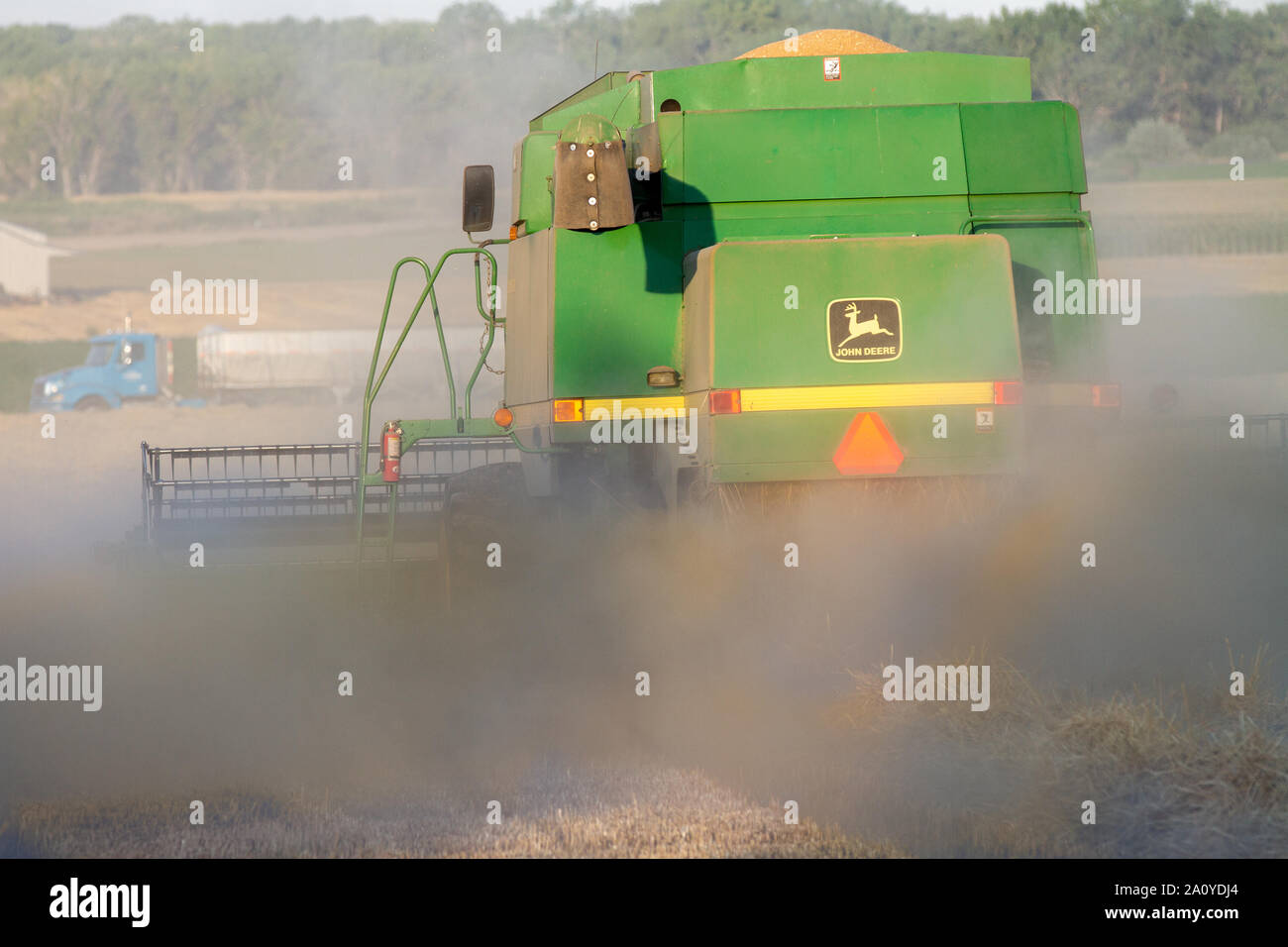 Tractor plowing the fields during the summer harvest Stock Photo - Alamy
