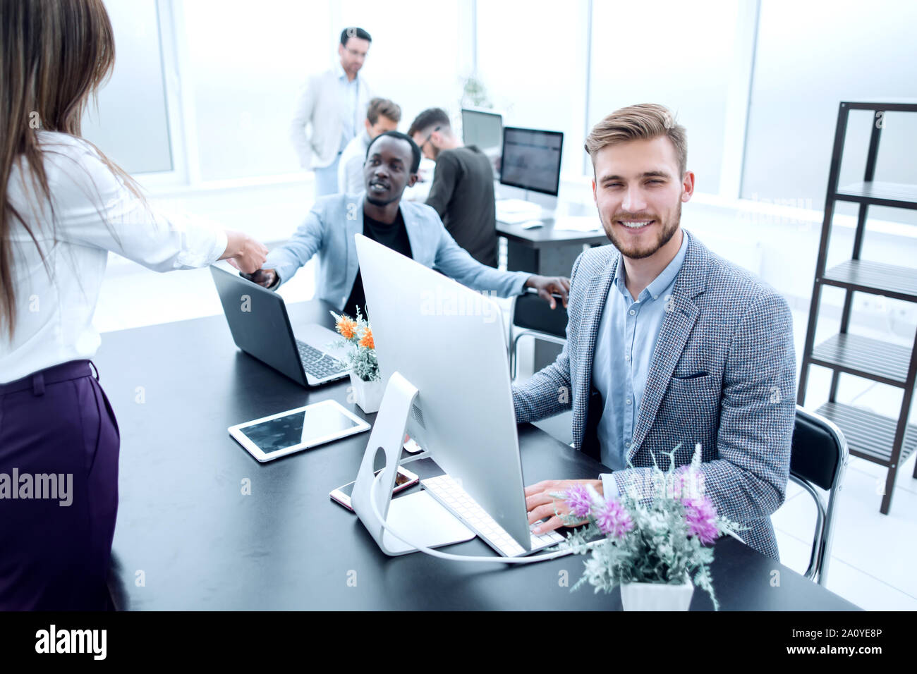employee sitting at his Desk in the office Stock Photo - Alamy