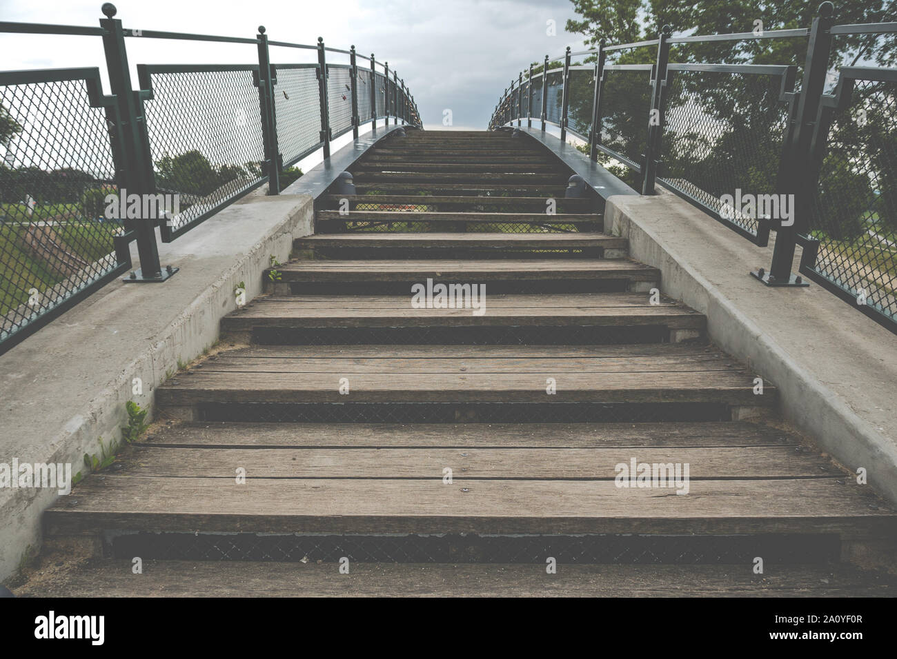 a small bridge with wooden stairs and metal balustrade Stock Photo - Alamy