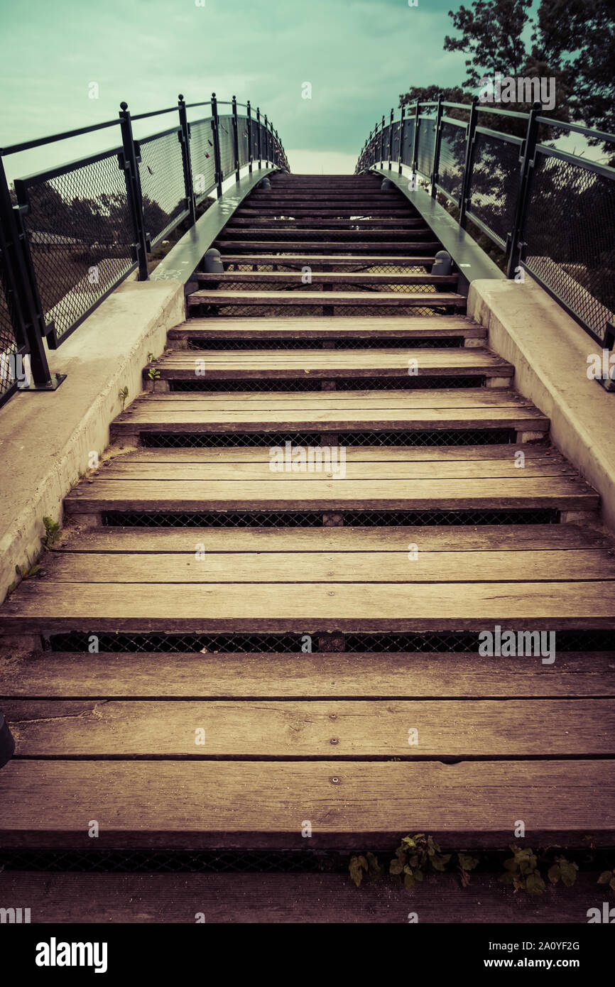 a small bridge with wooden stairs and metal balustrade Stock Photo - Alamy
