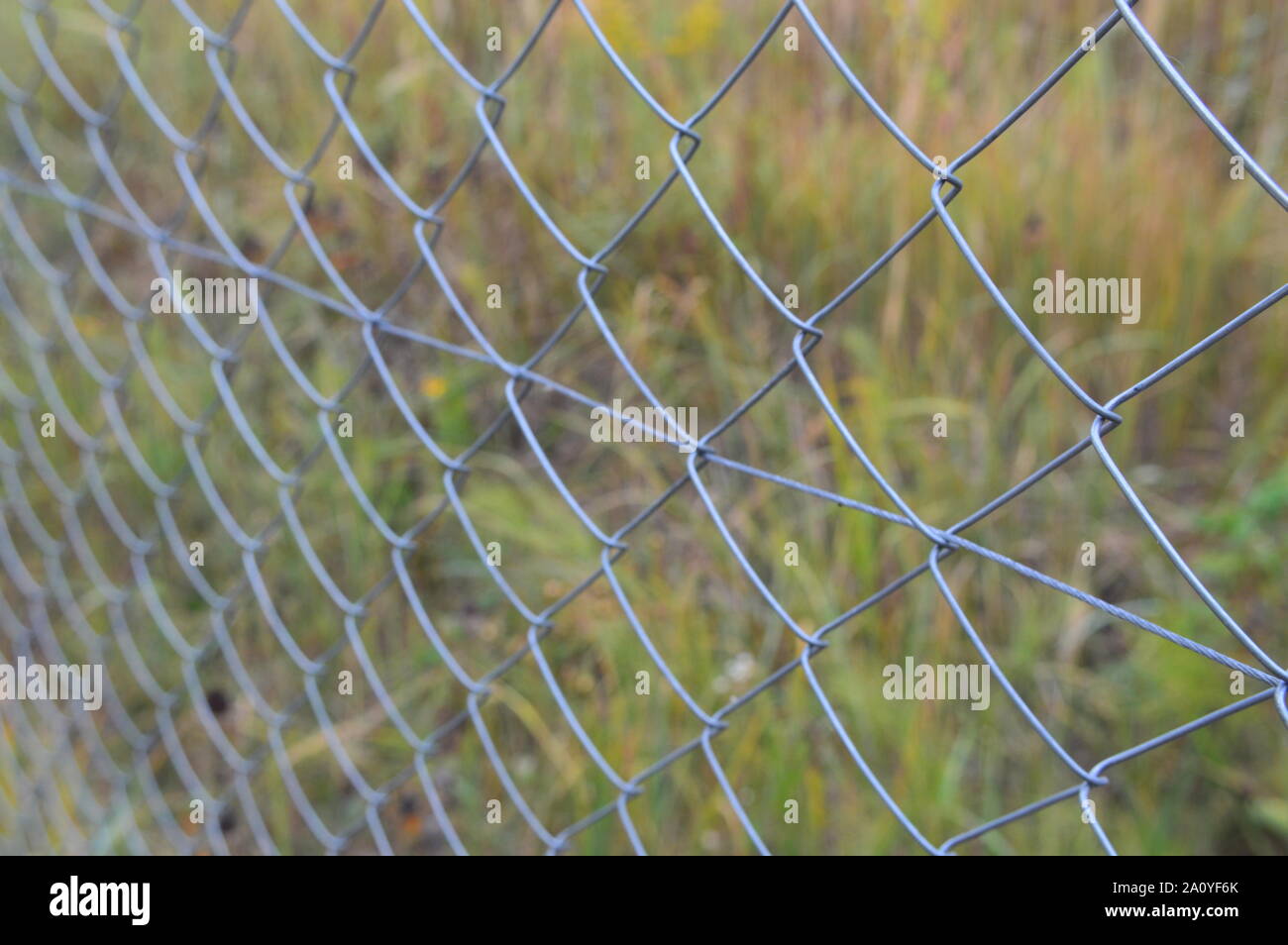 Barbed wire stretched on a fence for security Stock Photo - Alamy
