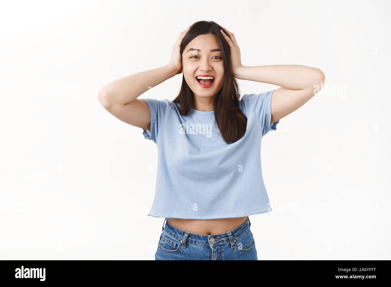 Girl crazy in love. Cheerful positive cute asian woman hold hands head ...