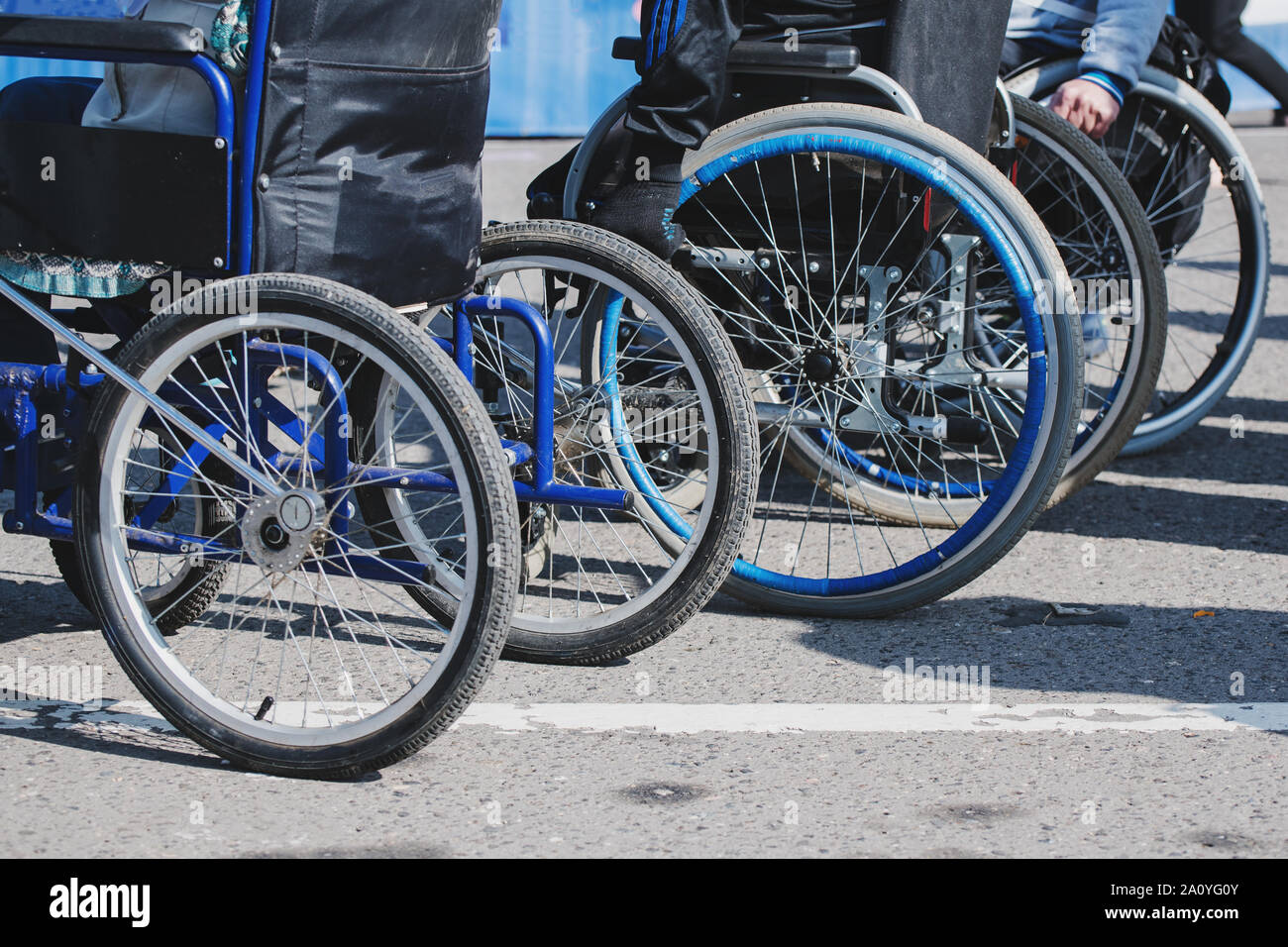 Wheelchair wheels closeup on asphalt. The concept of social equality ...