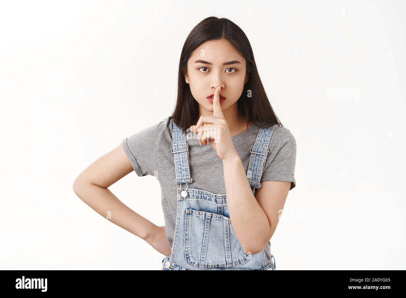 You better keep quiet. Annoyed serious-looking intense young bothered ...