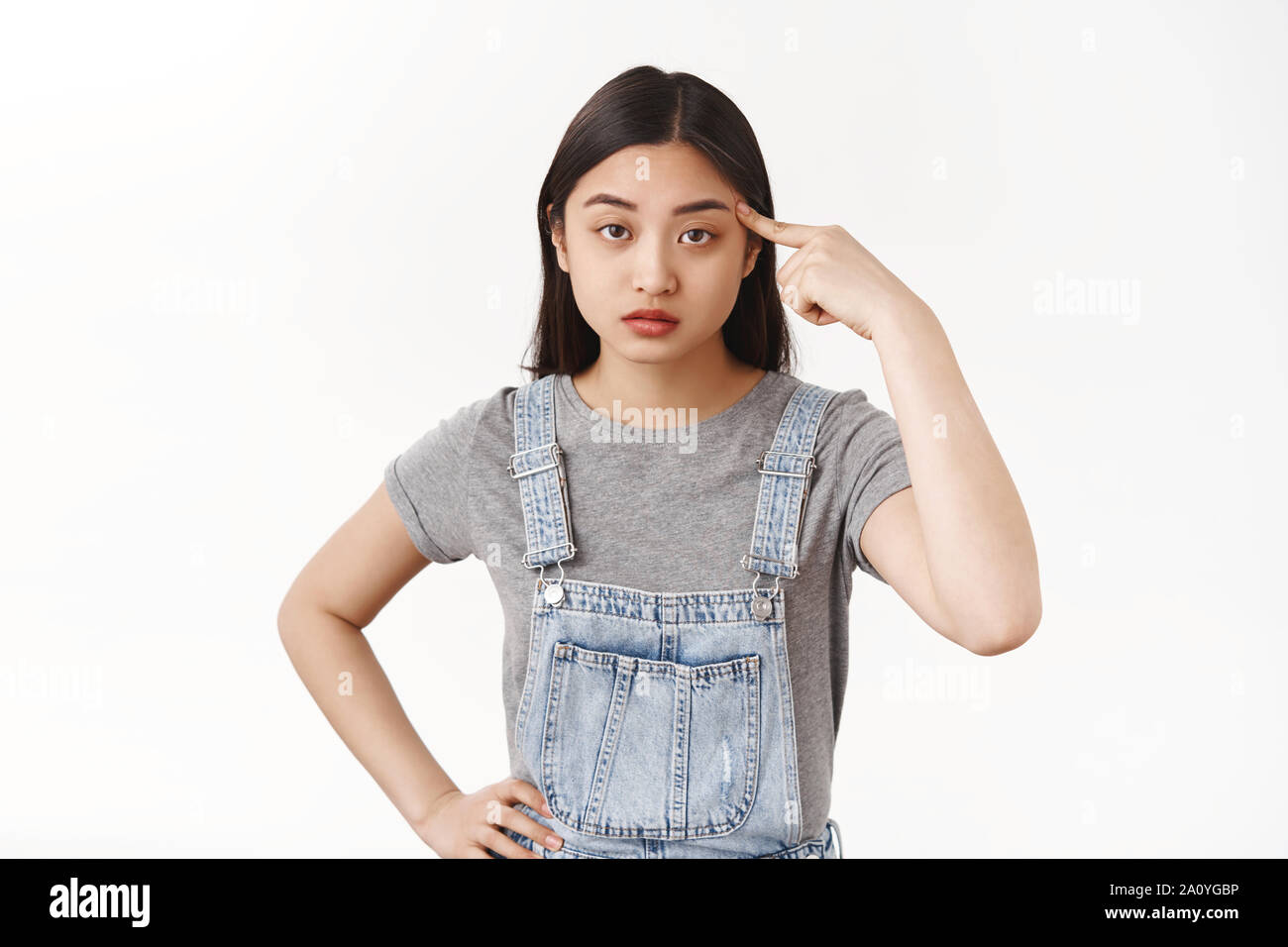 Are you dumb. Asian young female friend roll index finger temple scorn ...