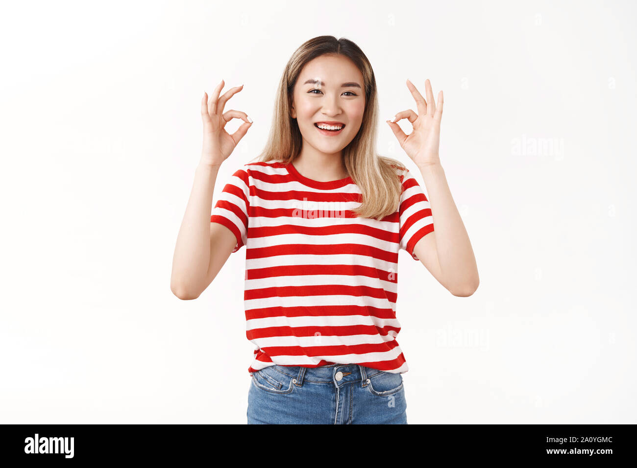 Well done approving. Cheerful satisfied cute friendly blond asian girl ...