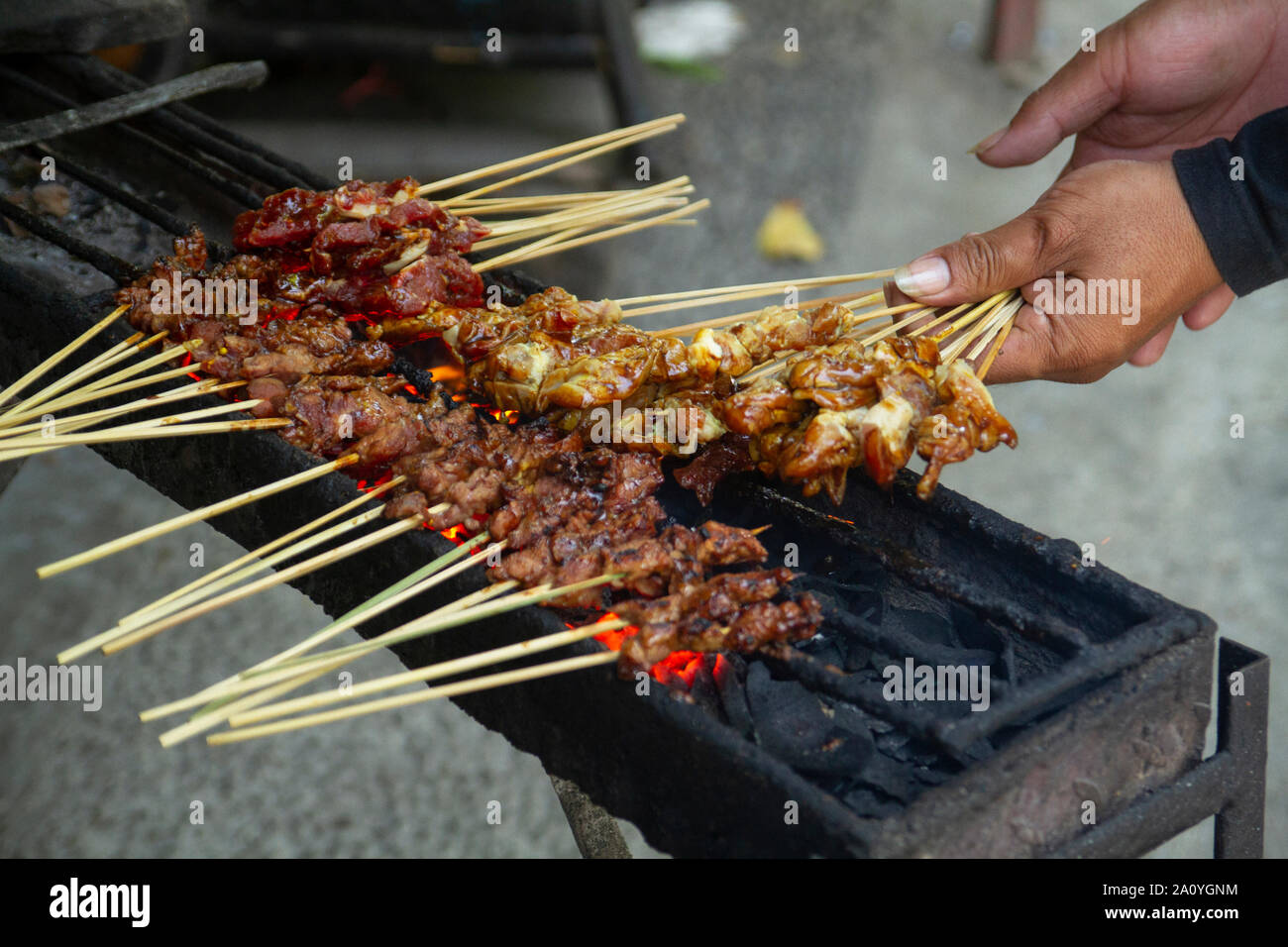 Chicken satay grill at a busy street food market Stock Photo - Alamy