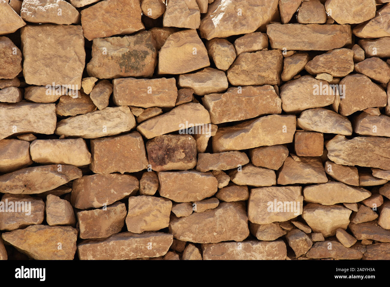 Stone wall made with rocks without concrete. Unregular unique structure ...