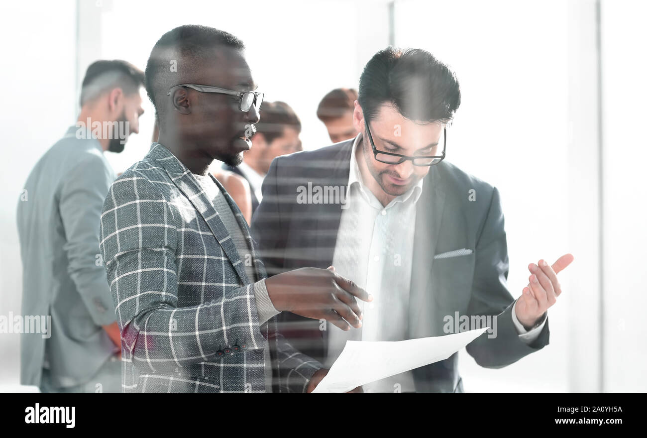 business colleagues discussing a working paper Stock Photo - Alamy