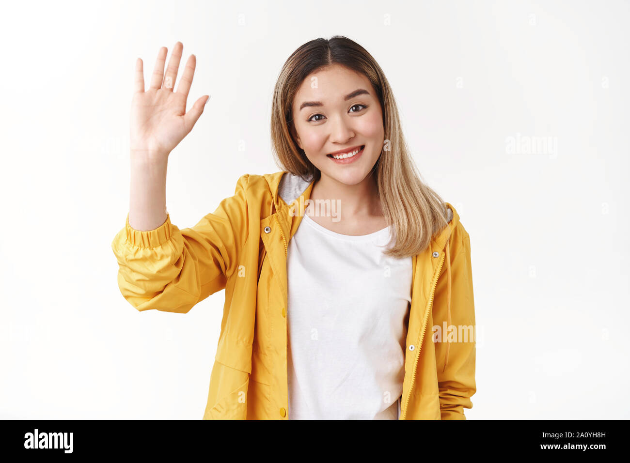 Friendly cute cheerful outgoing asian blond girl raise hand up high ...