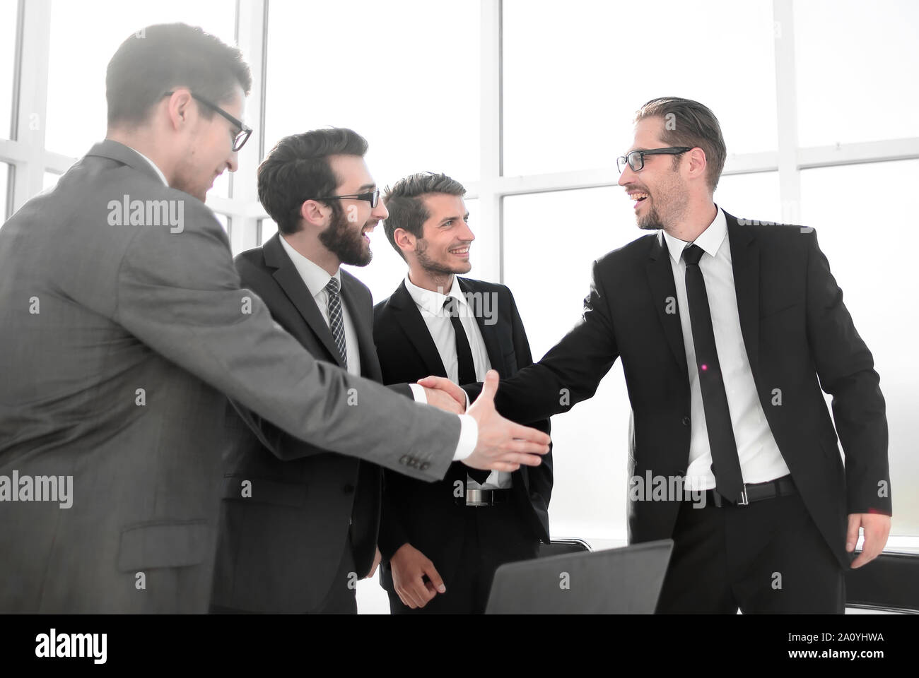 boss and employee shaking hands with each other Stock Photo - Alamy