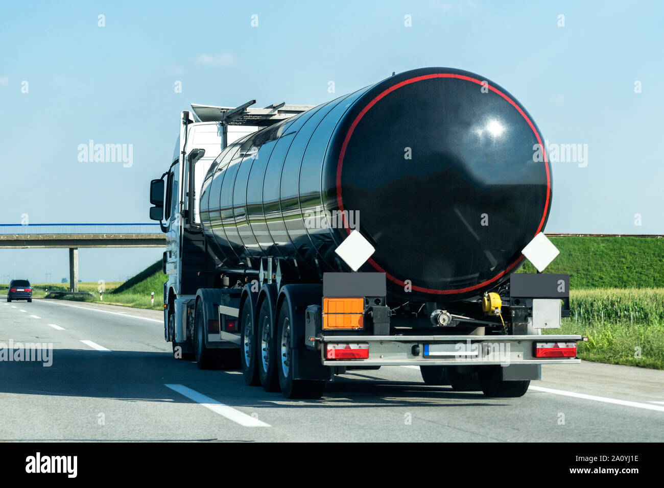 Tank truck on a rural country highway or motorway with light traffic ...