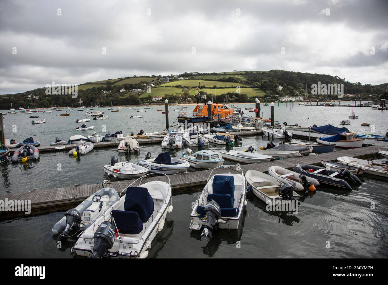 Harbour in Salcombe estuary, RNLI boat and small boats around with ...