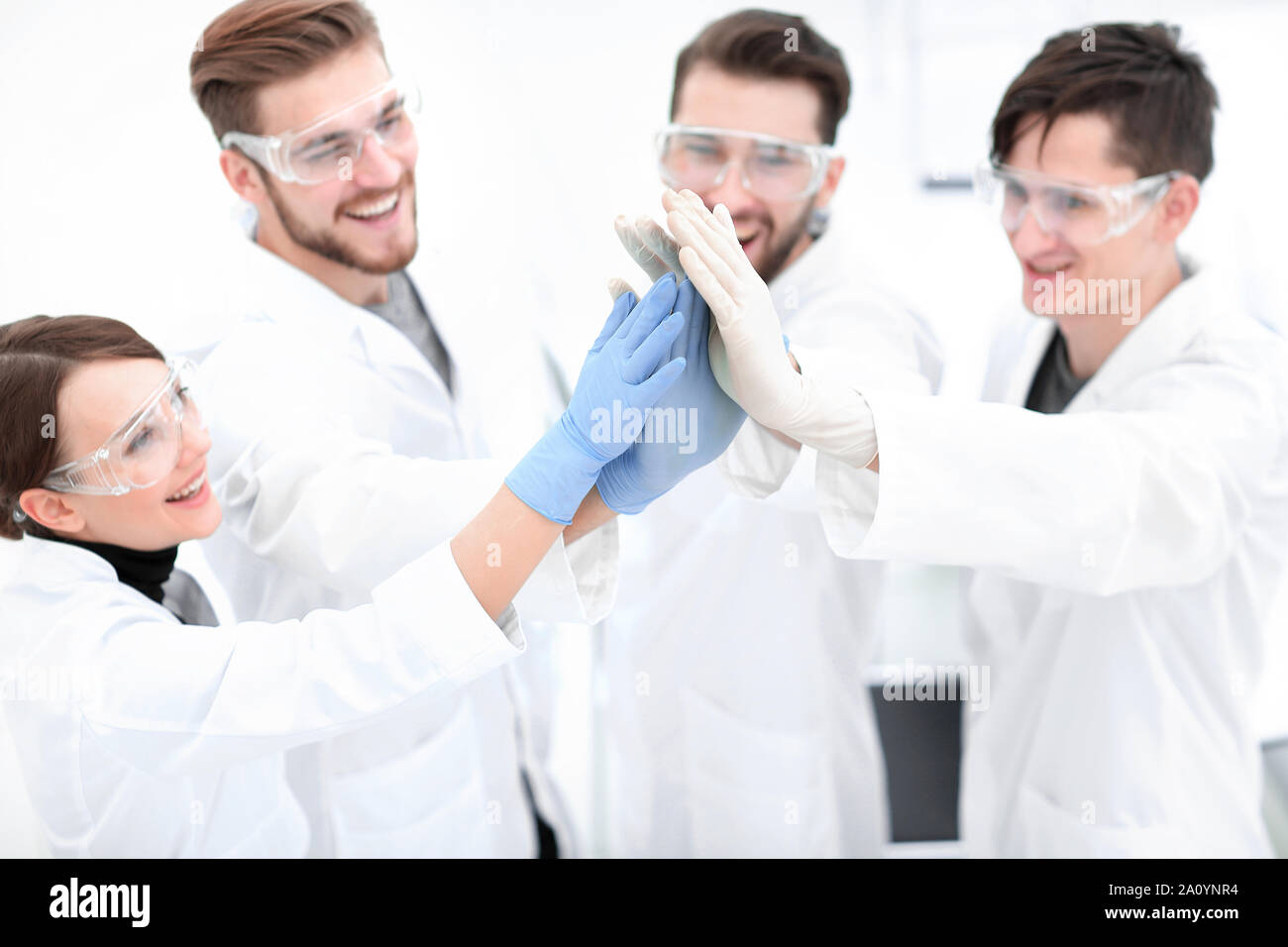 scientists giving each other a high five Stock Photo - Alamy