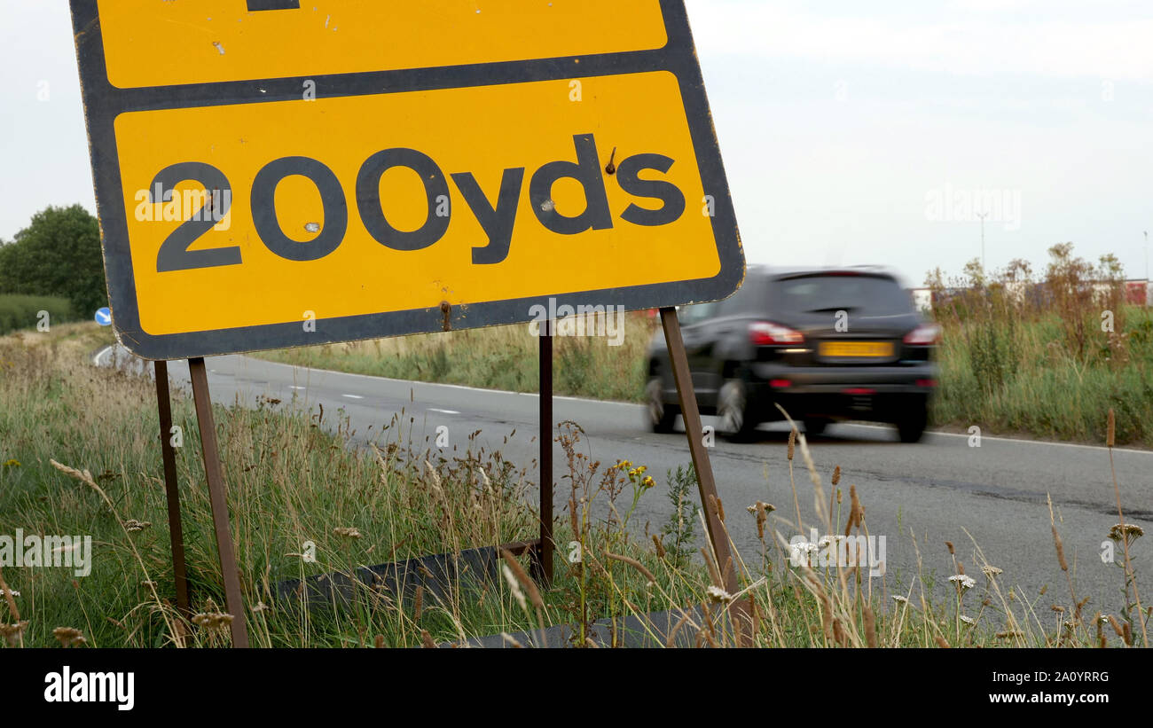 200 yards roadworks warning sign on UK motorway at evening with traffic ...