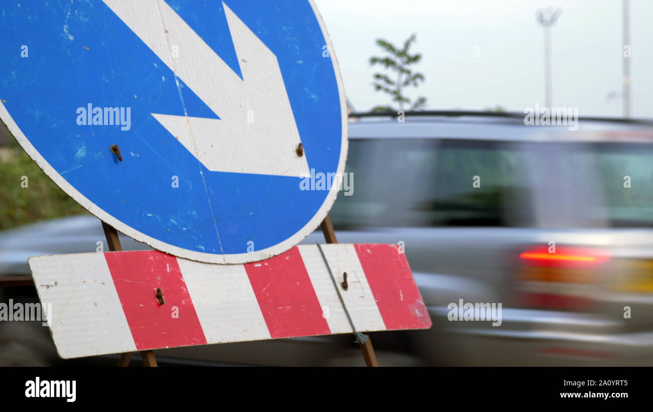 roadworks directional arrow sign on UK motorway at evening with traffic ...