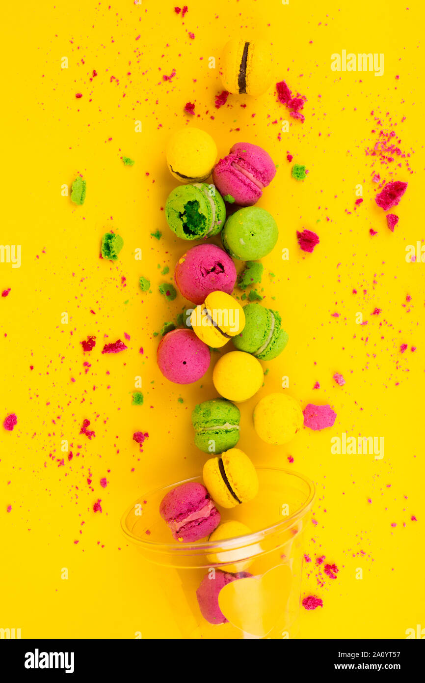 Colored, bright, sweet macaroons on a yellow background. Antigravity ...