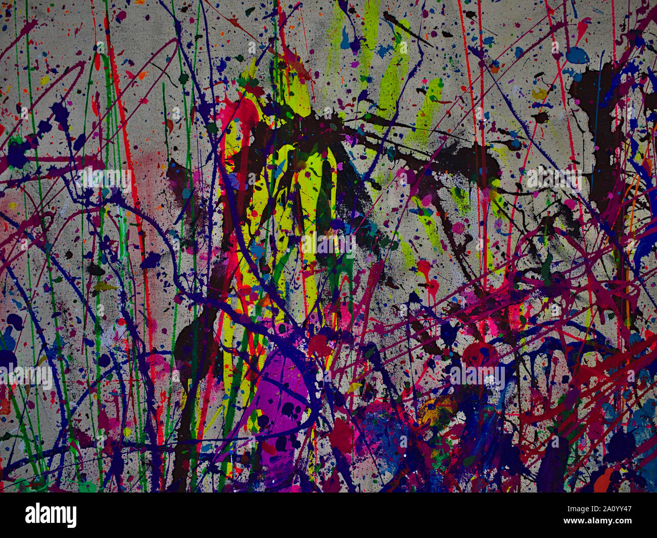 Paint splattered on a cloth background while making spatter art. In an ...