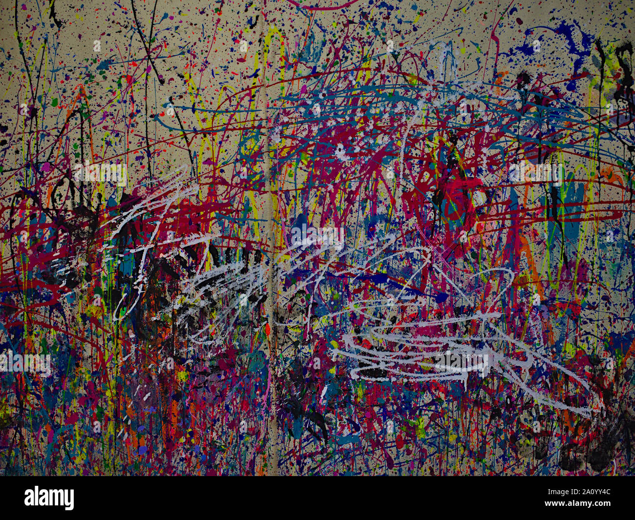 Paint splattered on a cloth background while making spatter art. In an ...