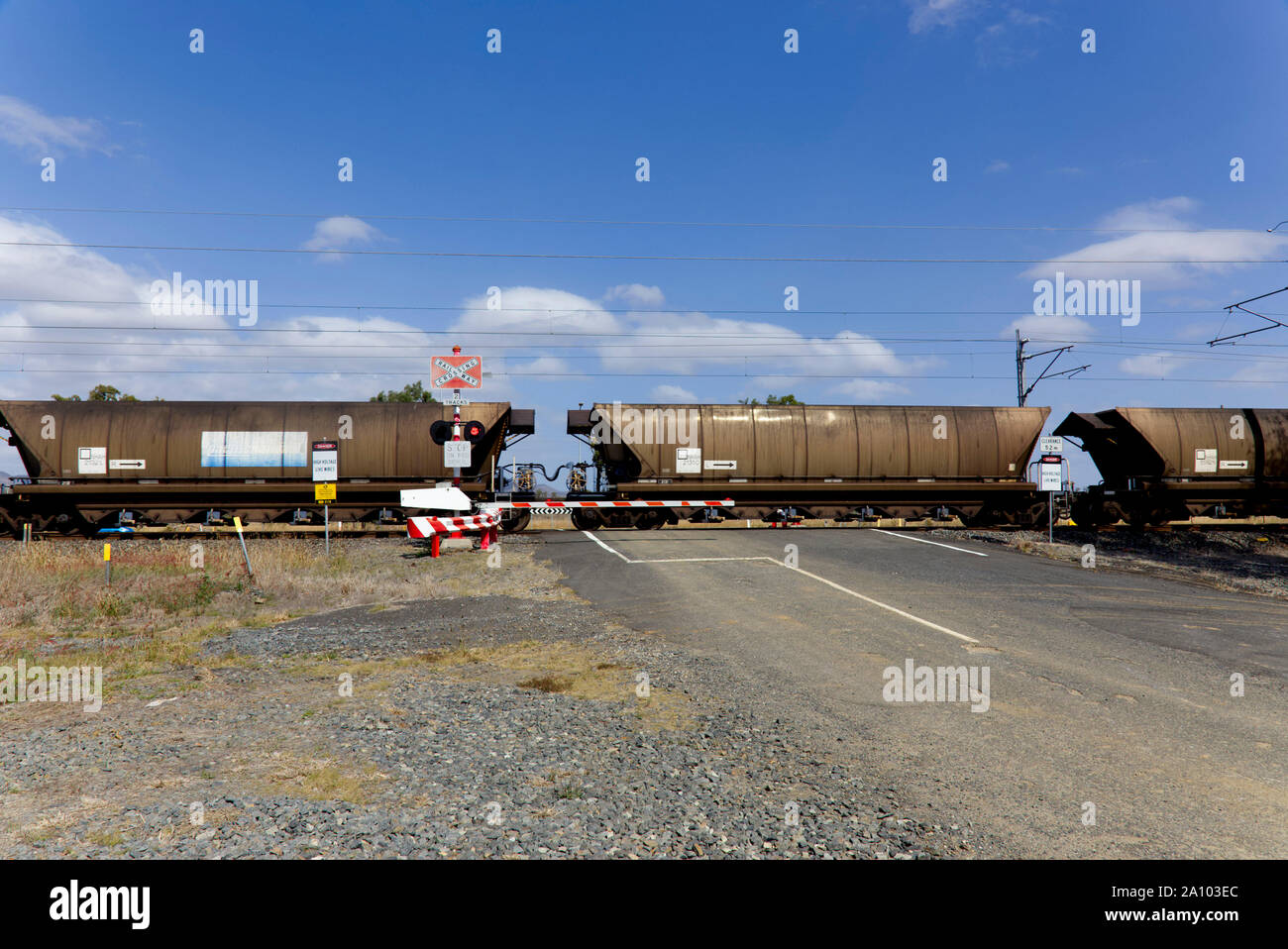Coal trains at a controlled level crossing near Mount Larcom Queensland ...