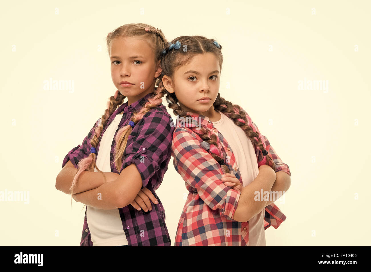 Girls sisters stand back to back confidently. Friendship support and ...