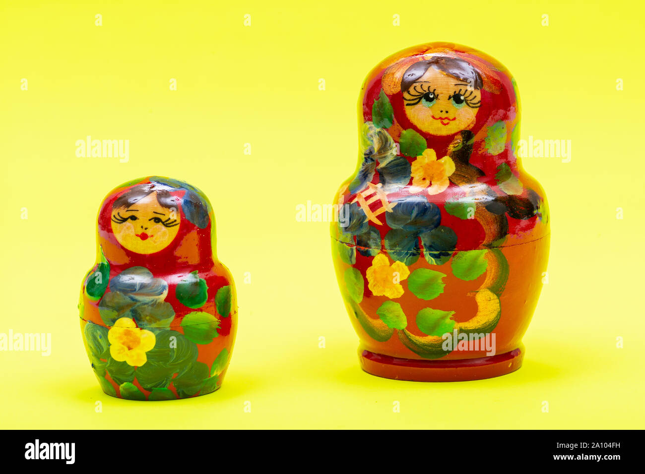 Colorful Nesting wooden Dolls isolated on bright yellow background ...