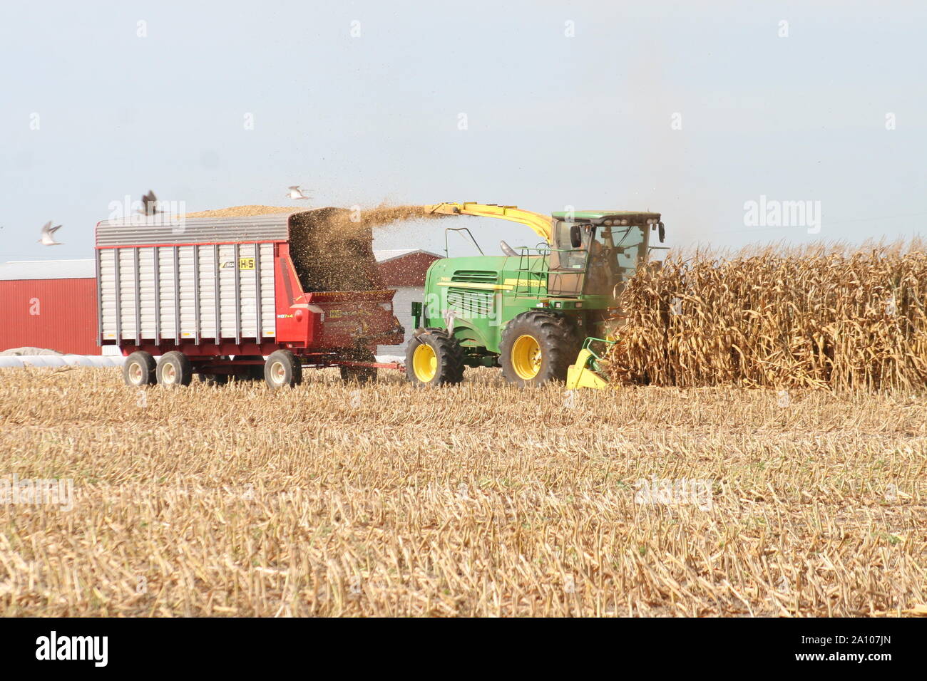 Small combine with grain cart Stock Photo - Alamy