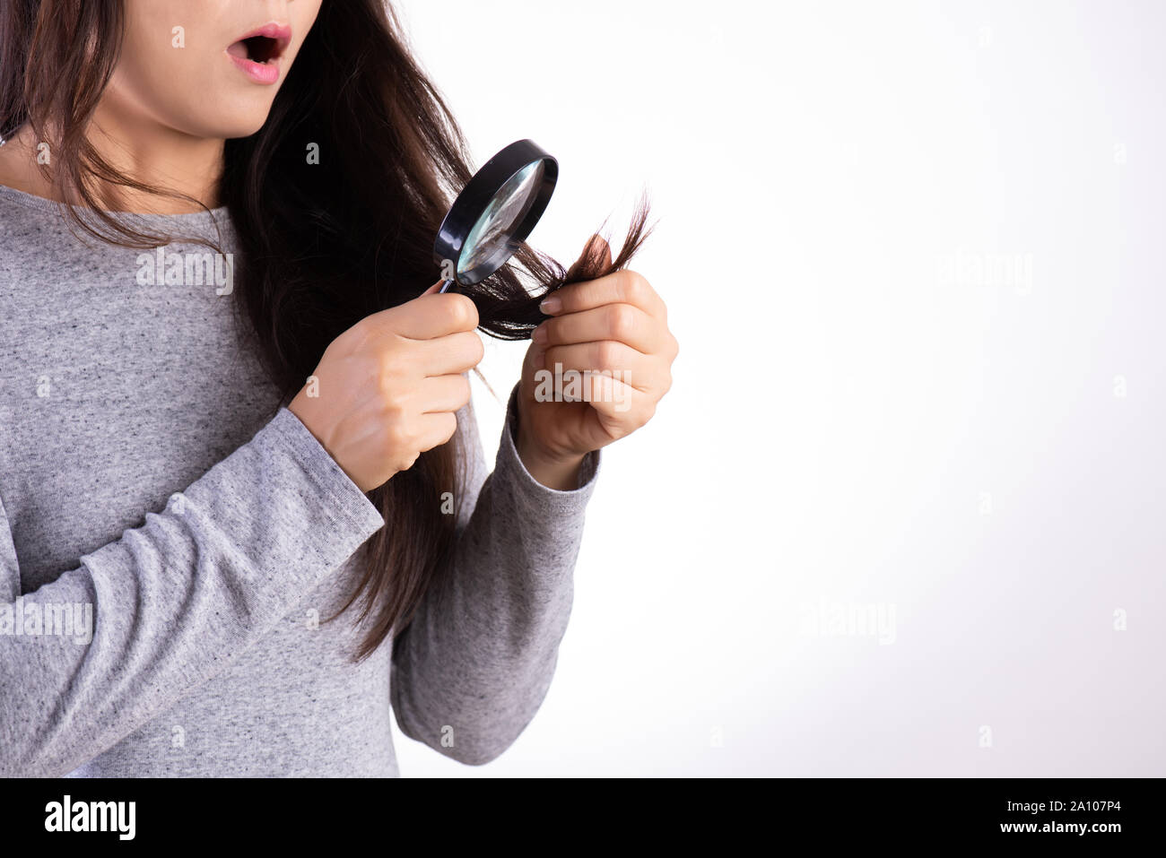 Healthy concept. Woman looking through a magnifying glass ends of her ...
