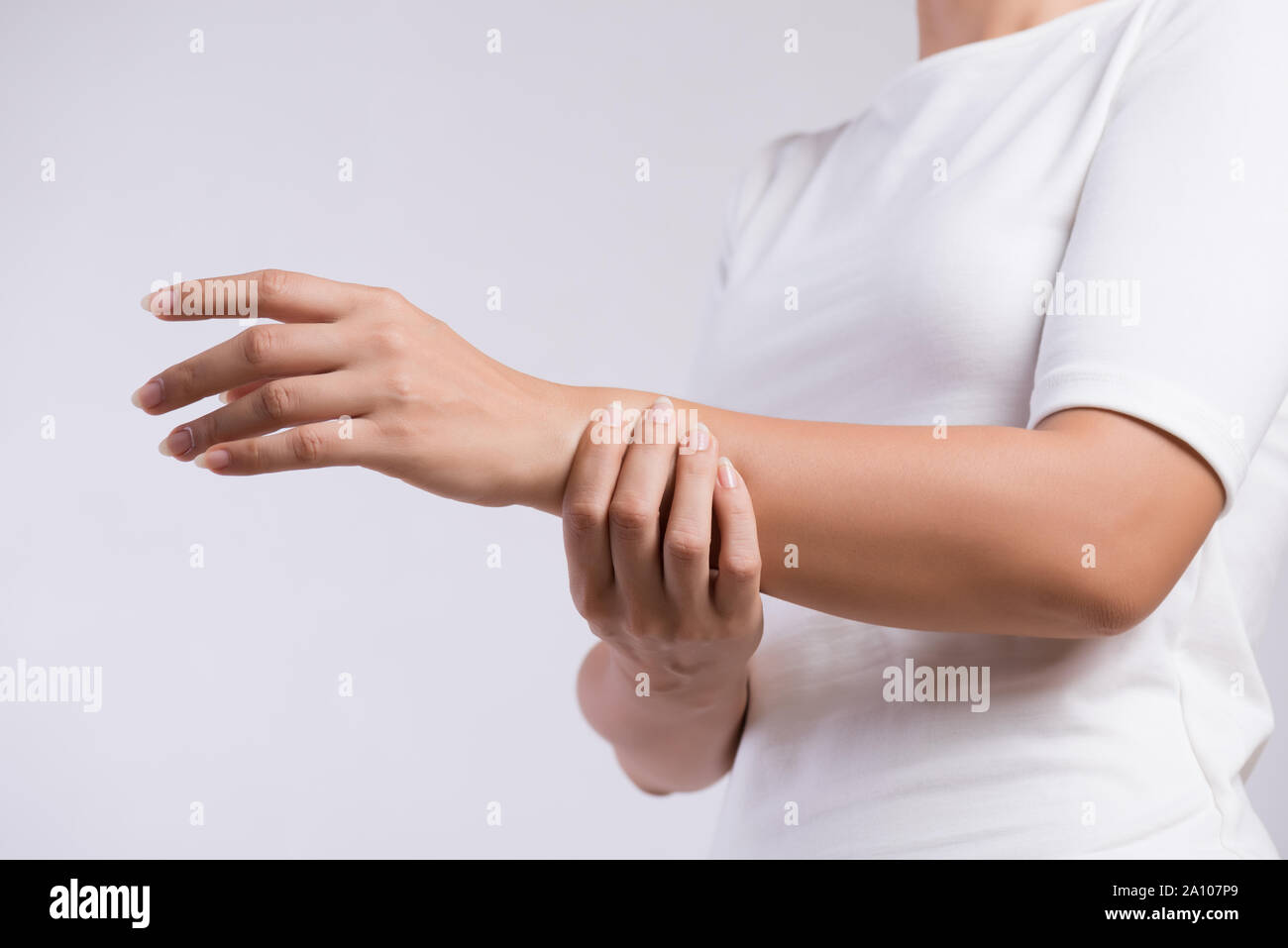 Closeup woman holds her wrist hand injury, feeling pain. Health care ...
