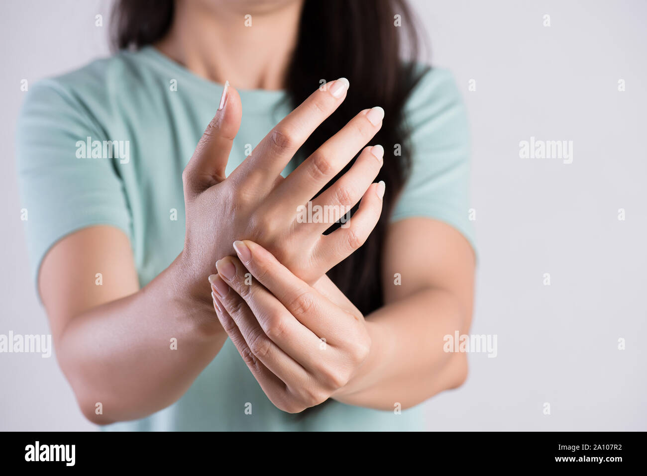 Closeup woman holds her wrist hand injury, feeling pain. Health care ...